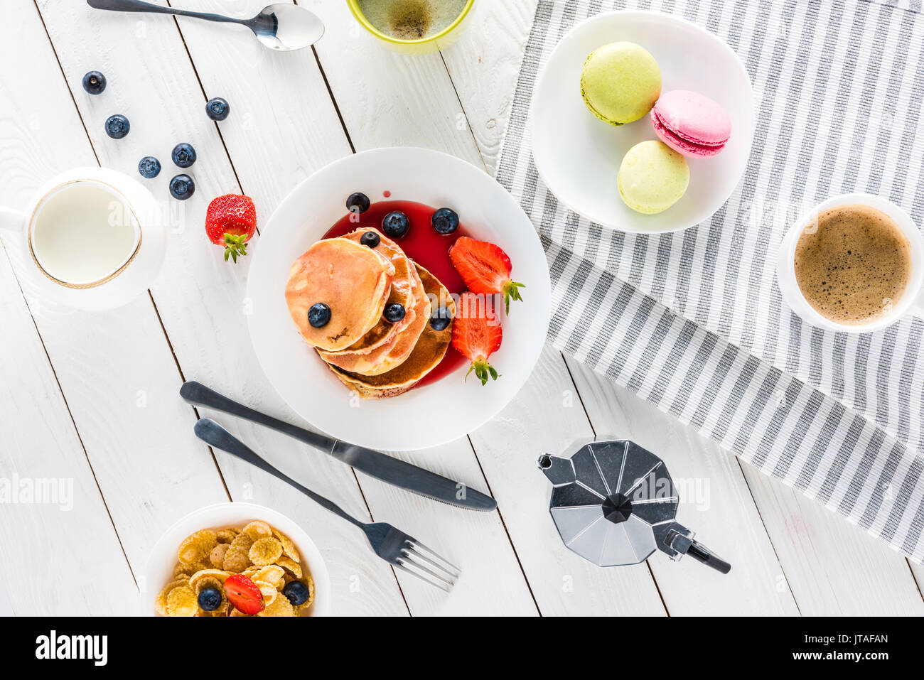 top view of pancakes with macarons and coffee with corn flakes on ...