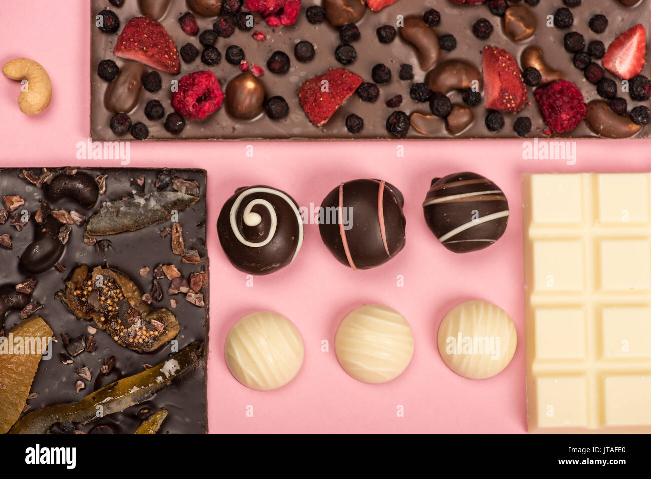 flat lay with assorted chocolate bars with fruits and nuts and candies ...