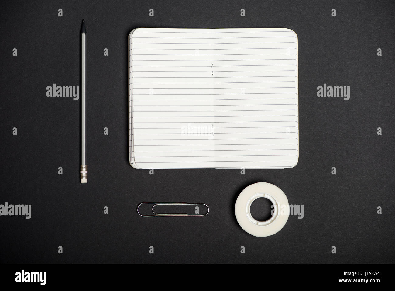 flat lay with pencil, notebook, paper clip and sticky tape isolated on ...