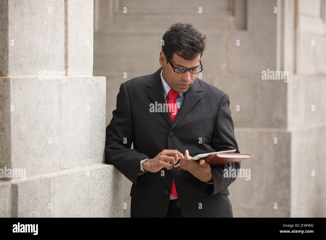 Indian business man with a tablet computer. Asian business man using ...