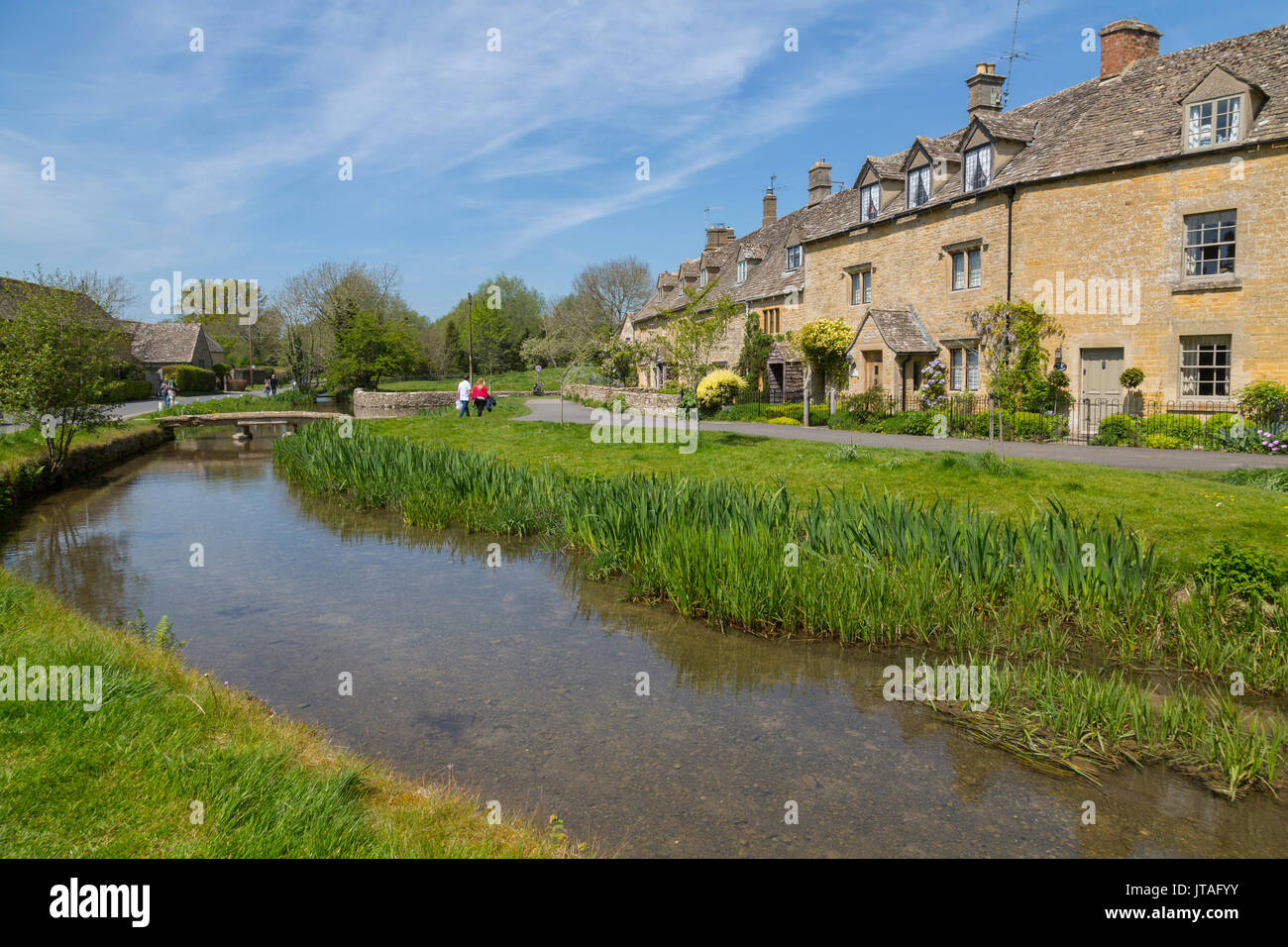 Cottages and footbridge over the River Eye in Lower Slaughter ...