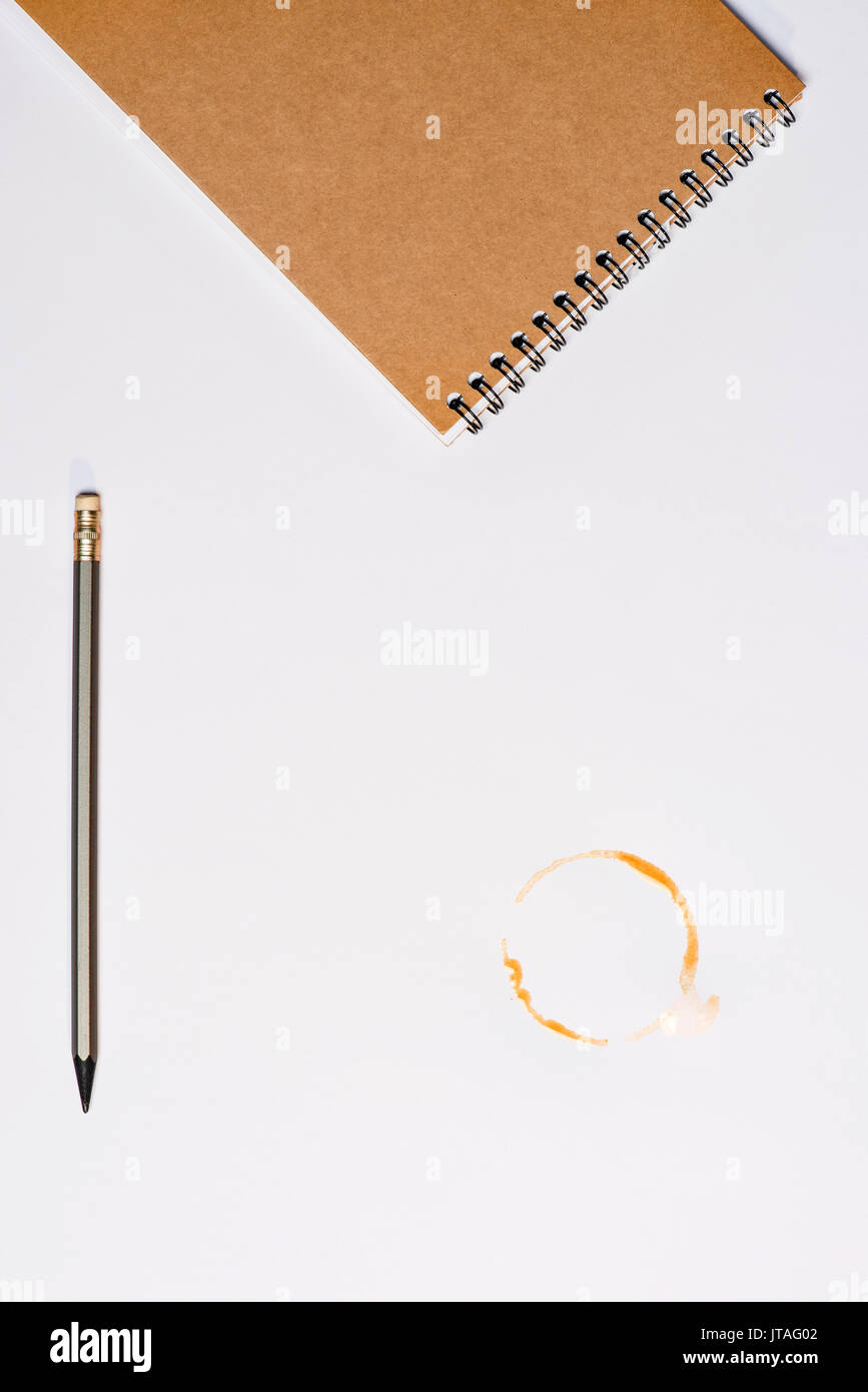 top view of notebook with pencil and coffee stain isolated on white ...