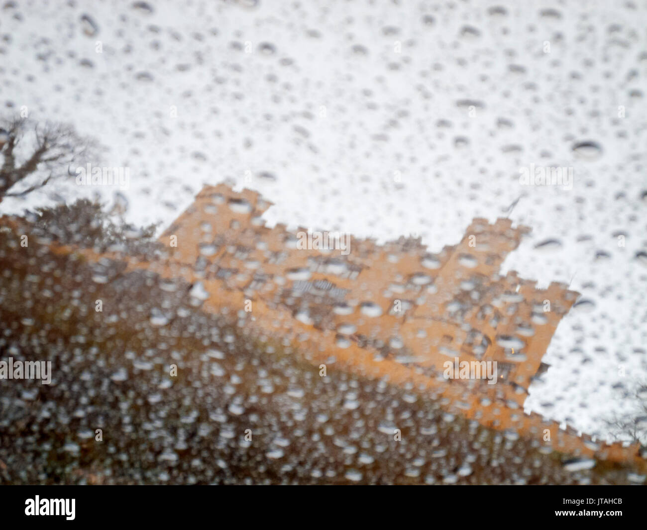 Slanted view of the lock Hohenschwangau behind a glass pane with ...