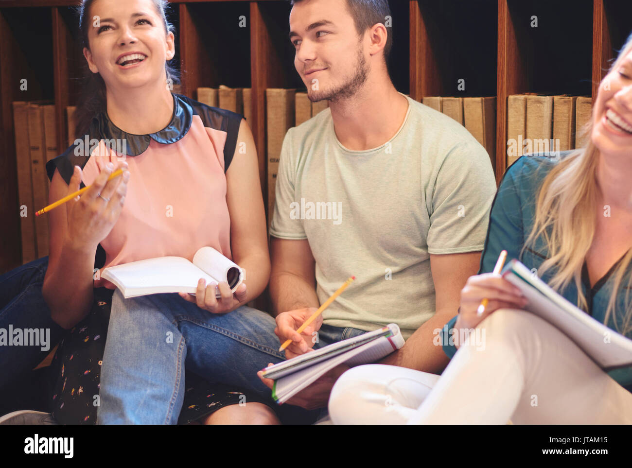 Young students meeting in library Stock Photo - Alamy
