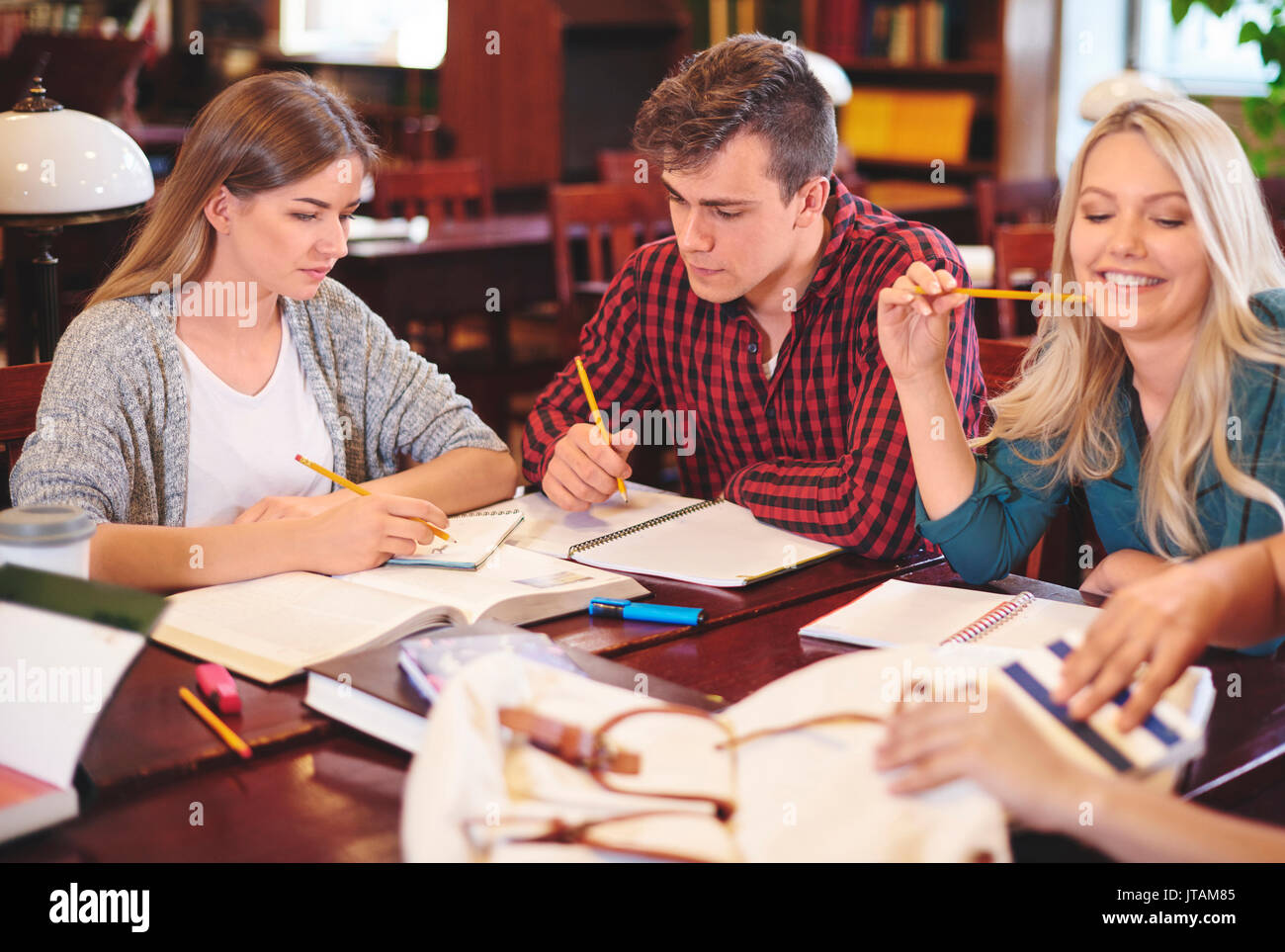 Students doing their homework together Stock Photo - Alamy