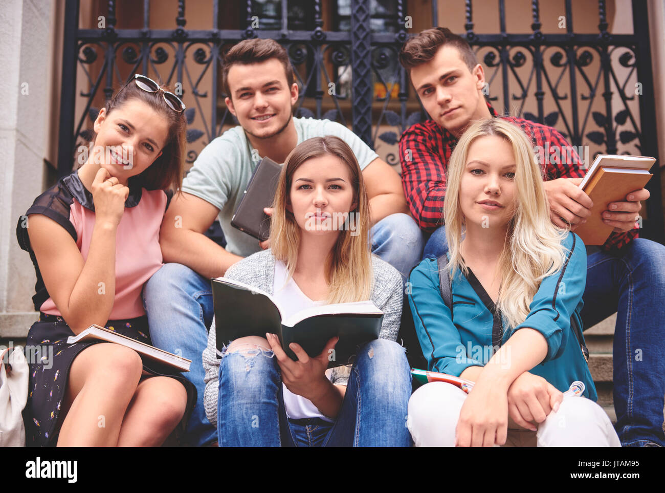 Group of people sitting on steps hi-res stock photography and images ...