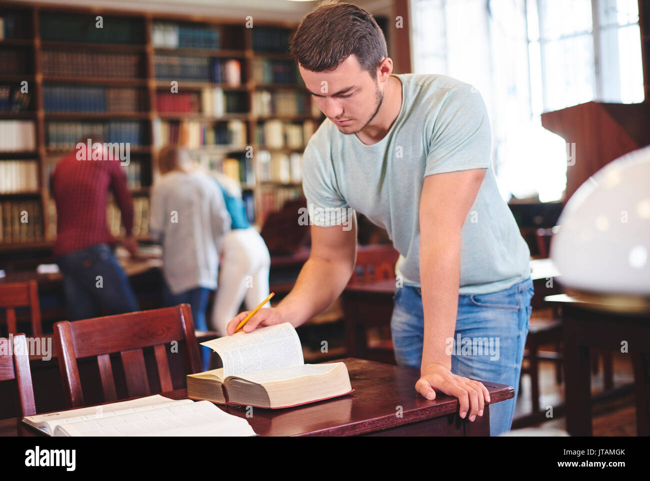 Man scouting out in book Stock Photo - Alamy