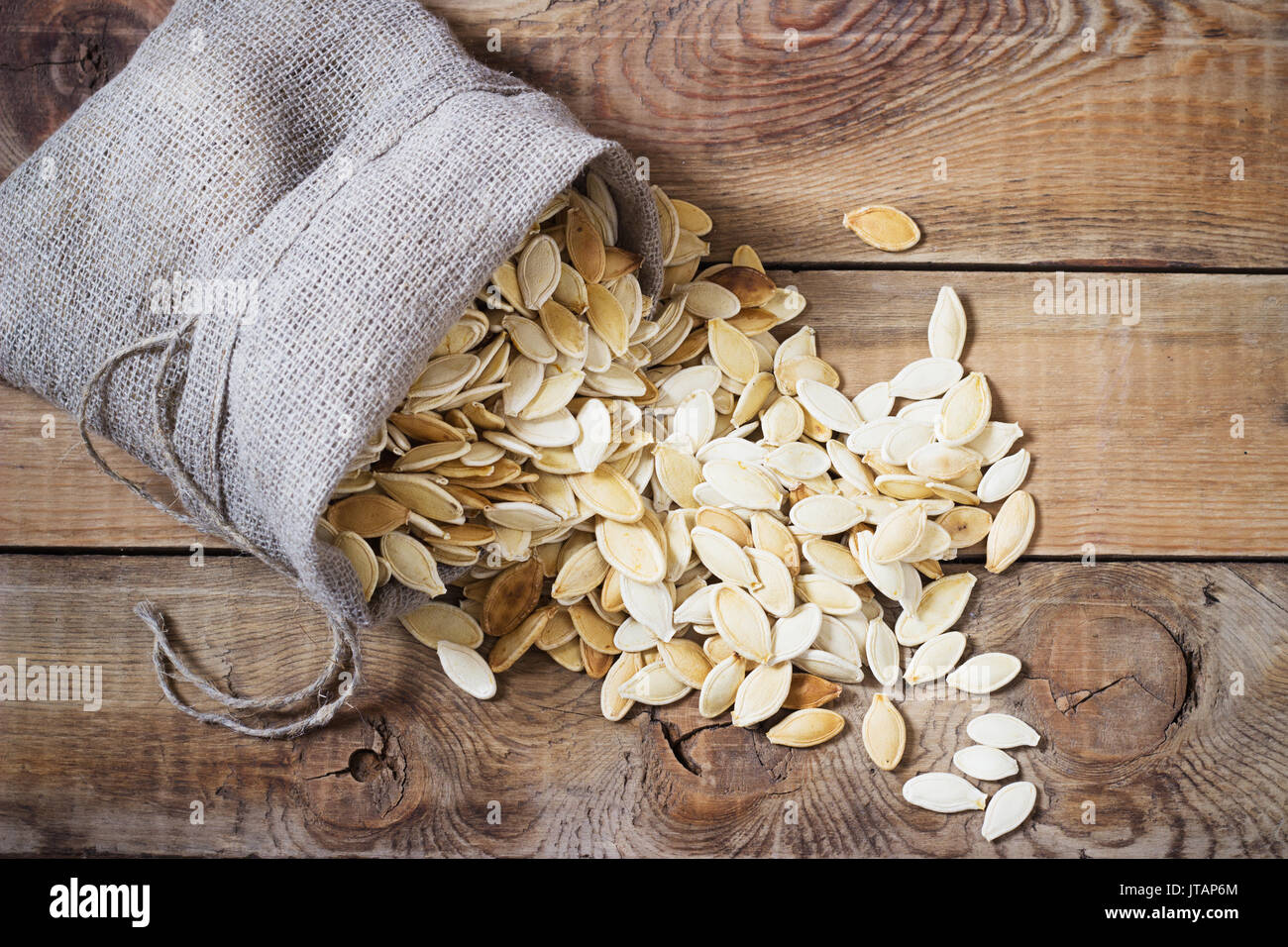 pumpkin seeds in bag on wooden background Stock Photo - Alamy