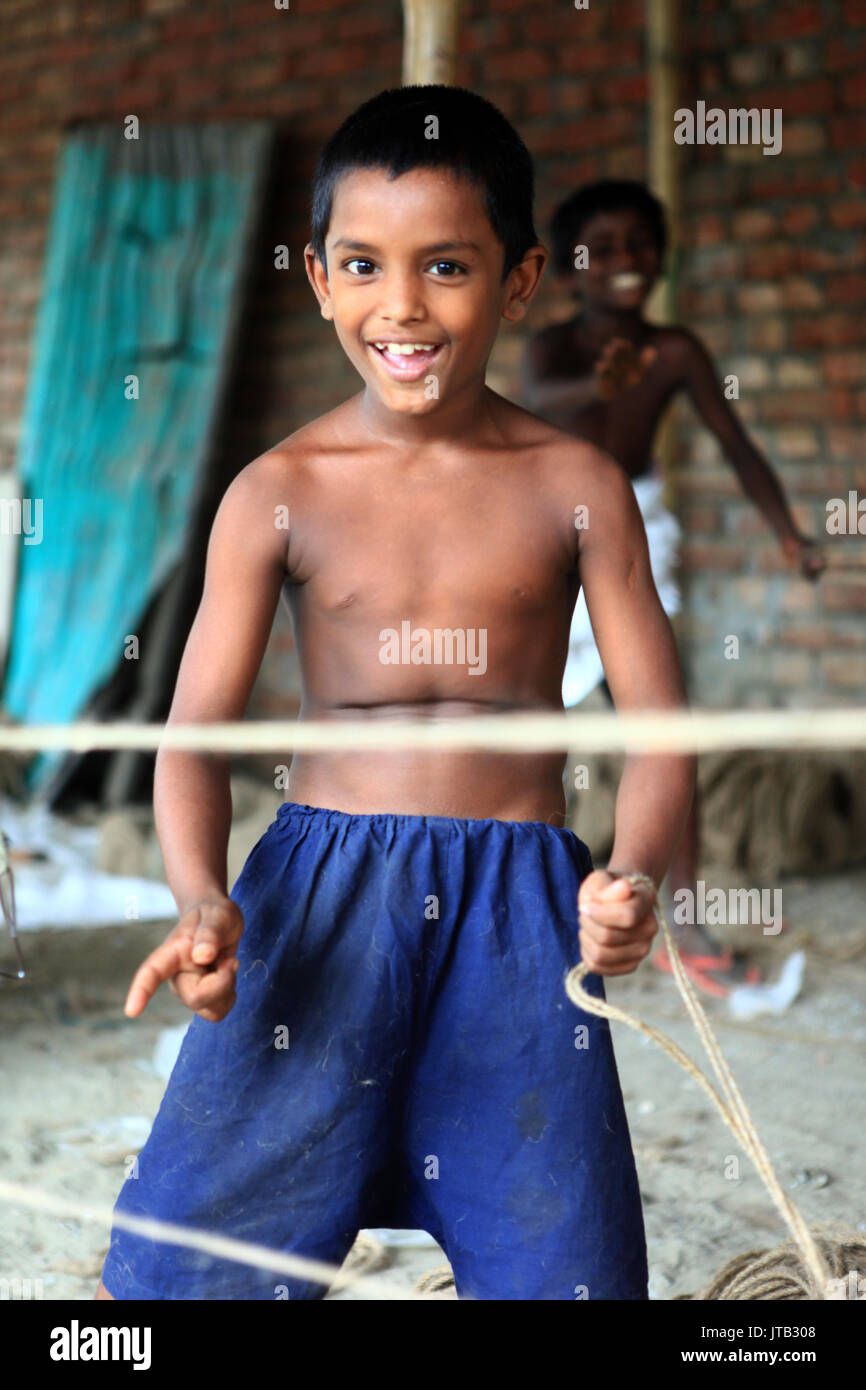 Child labours fun during working hours in a rope manufacturing factory ...