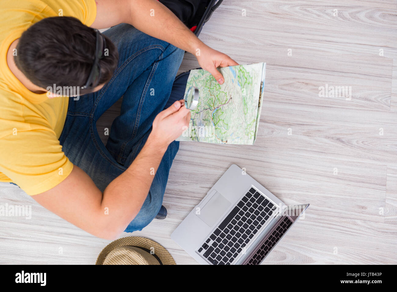 Man planning his vacation trip with map Stock Photo - Alamy
