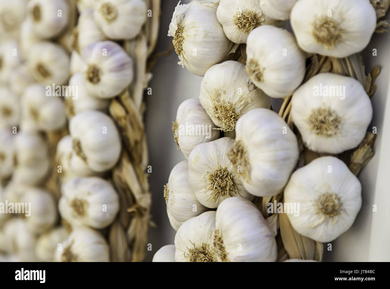 Strings of dried garlic in a traditional market Stock Photo - Alamy