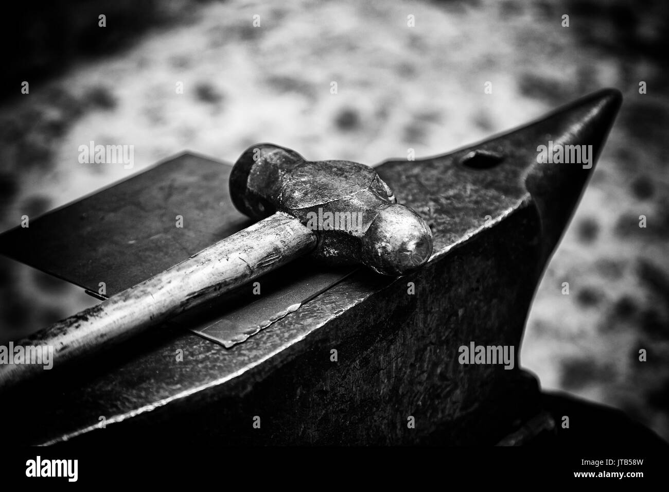 Old hammer and anvil on a forge, detail of old tool Stock Photo - Alamy