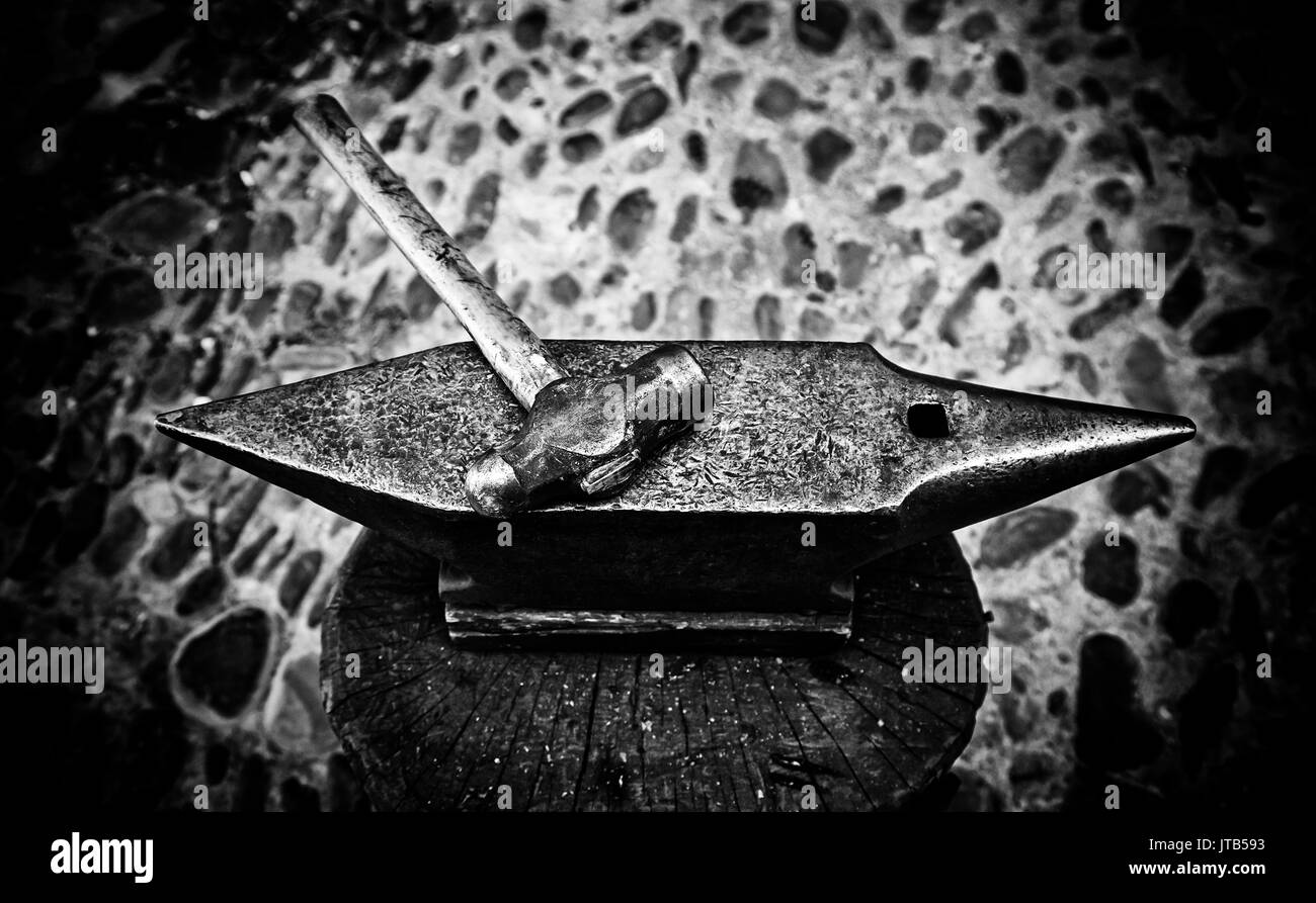 Old hammer and anvil on a forge, detail of old tool Stock Photo - Alamy