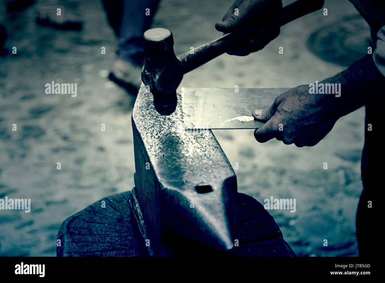 Old hammer and anvil on a forge, detail of old tool Stock Photo - Alamy