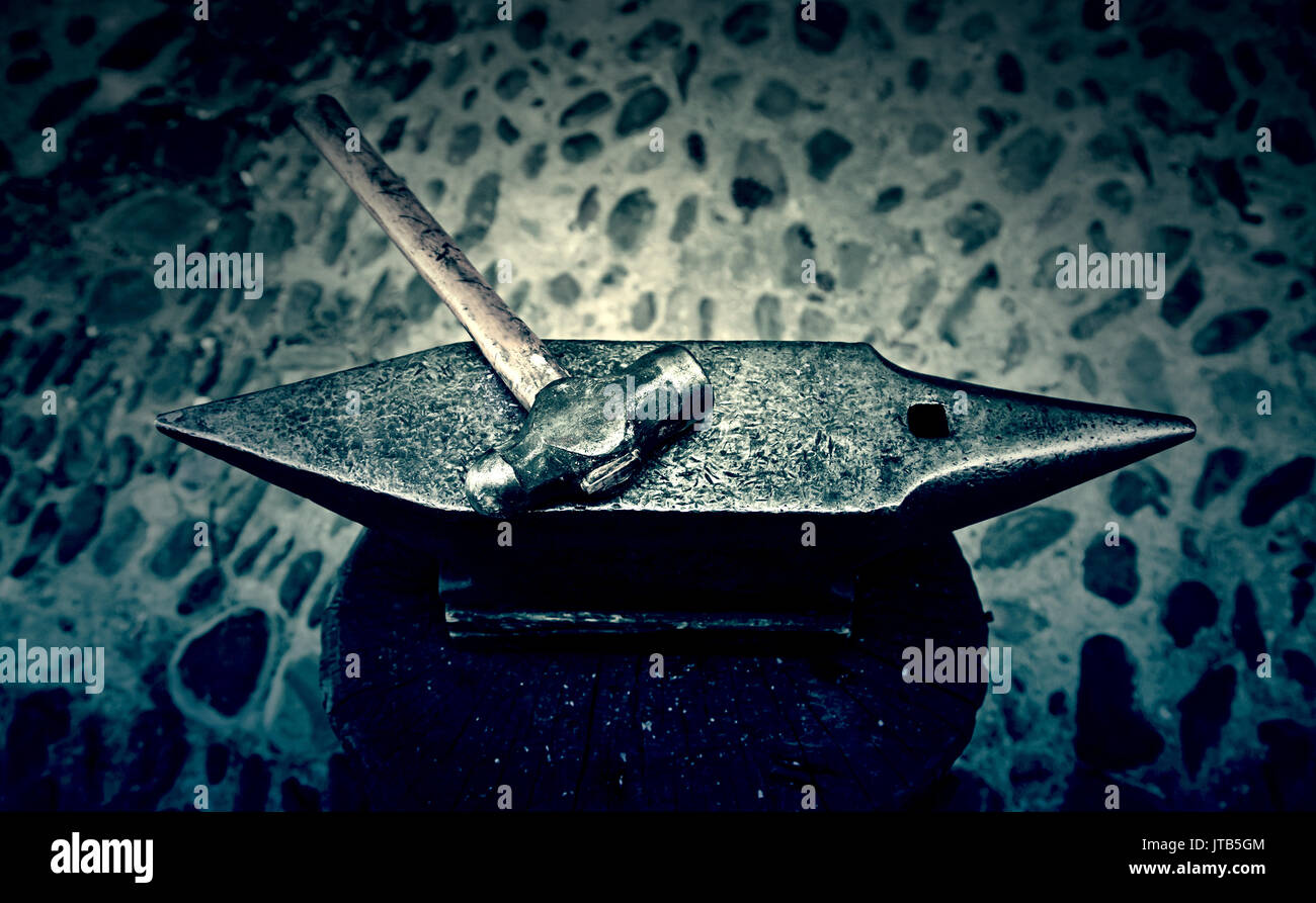 Old hammer and anvil on a forge, detail of old tool Stock Photo - Alamy