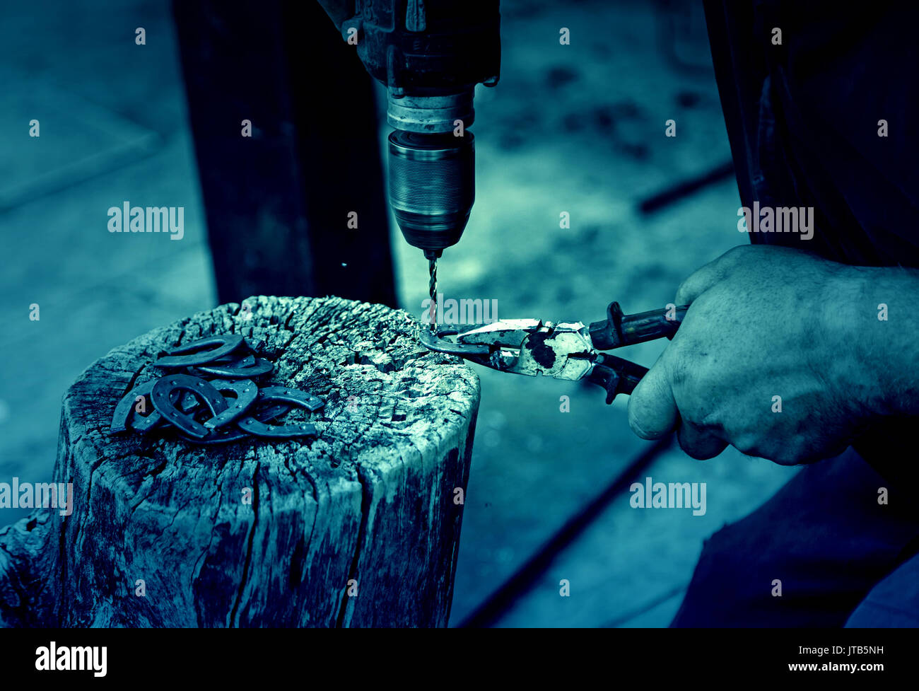 Hands, drill, detail of worker making holes in metal Stock Photo - Alamy