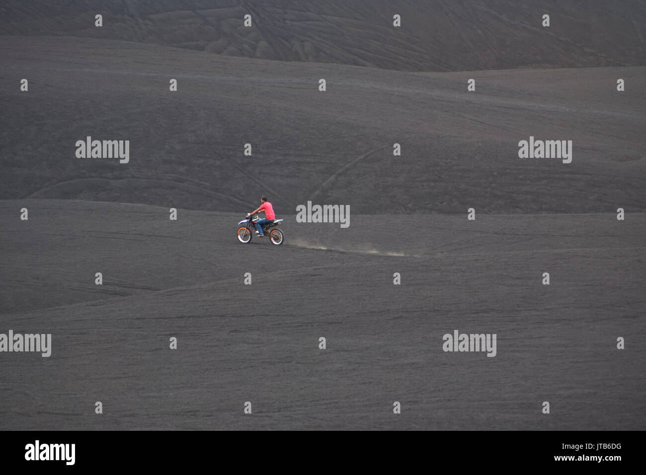 Riding bike in volcano ash in Nicaragua natural park Stock Photo - Alamy