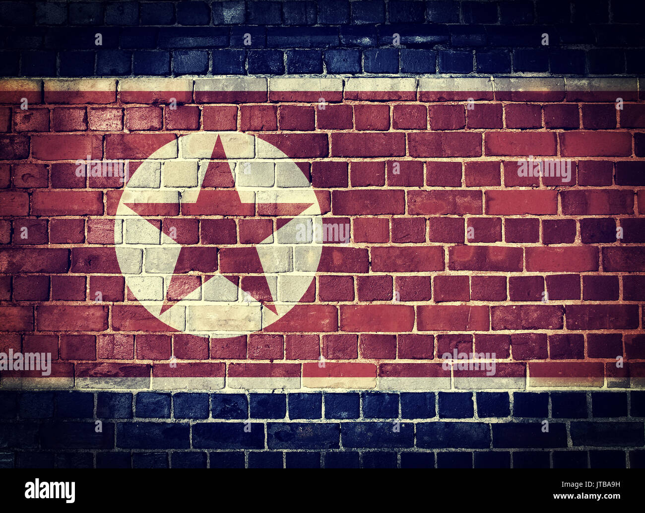 Faded North Korean flag on an old brick wall background with a dark ...