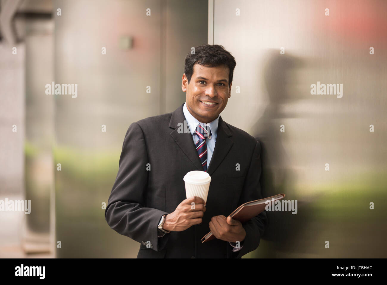 Indian business man with a tablet computer. Asian business man using ...