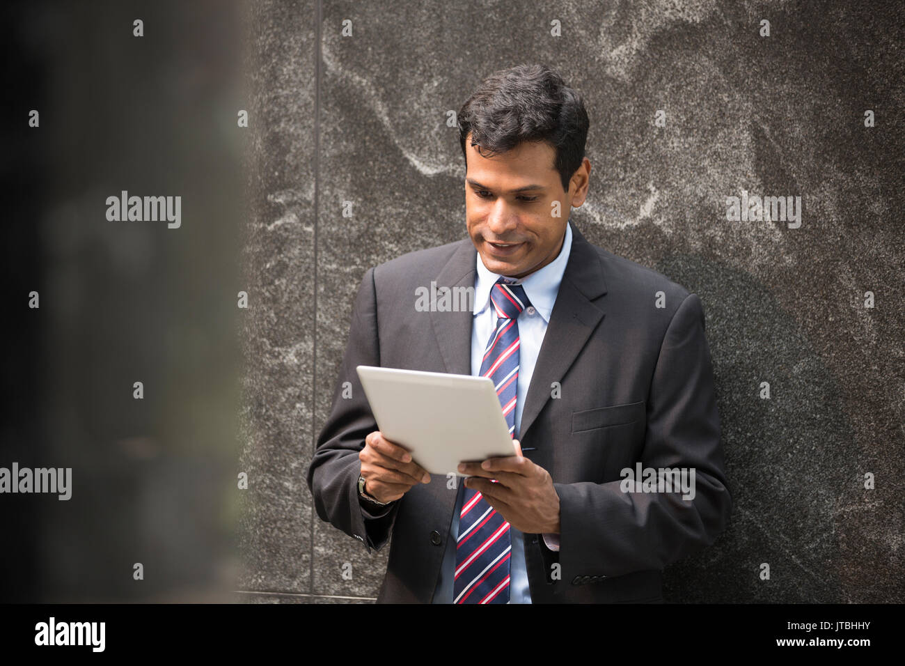 Indian business man with a tablet computer. Asian business man using ...