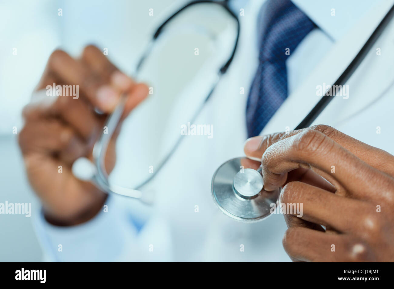 partial side view of doctor holding stethoscope in hands Stock Photo ...