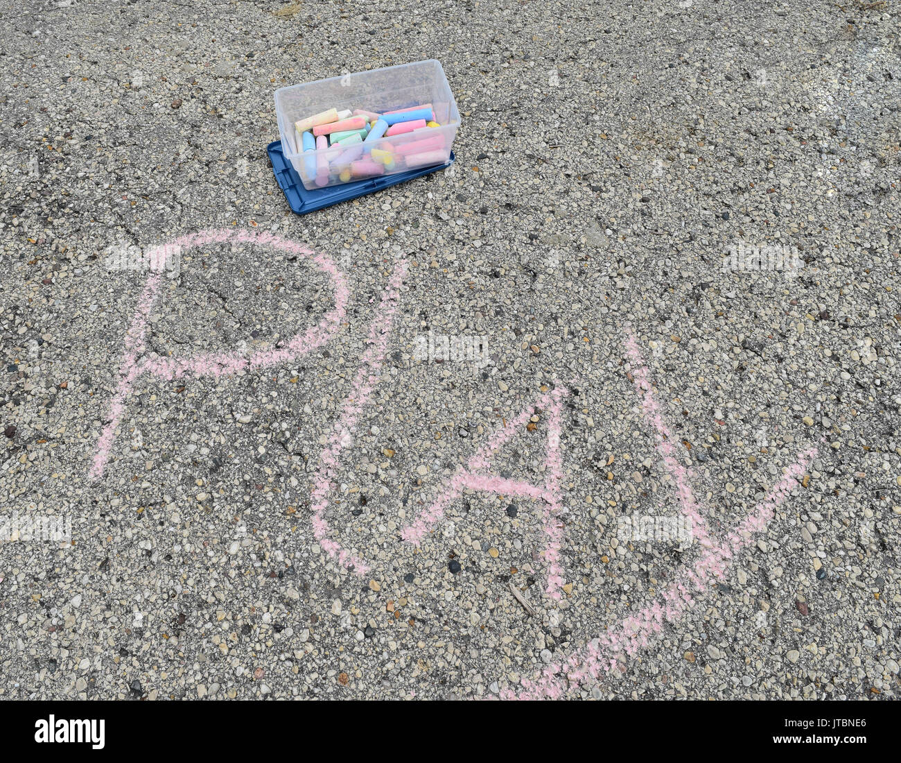 Sidewalk chalk on black top Stock Photo - Alamy