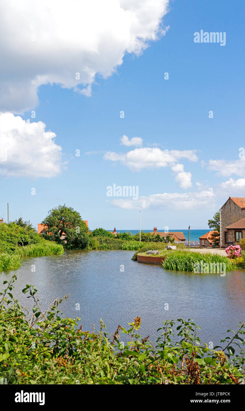 A view of the old Mill Pool in the North Norfolk village of Mundesley ...