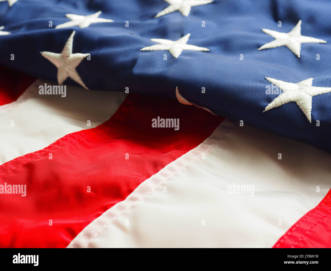 Detail of a partial folded American flag using as background Stock ...