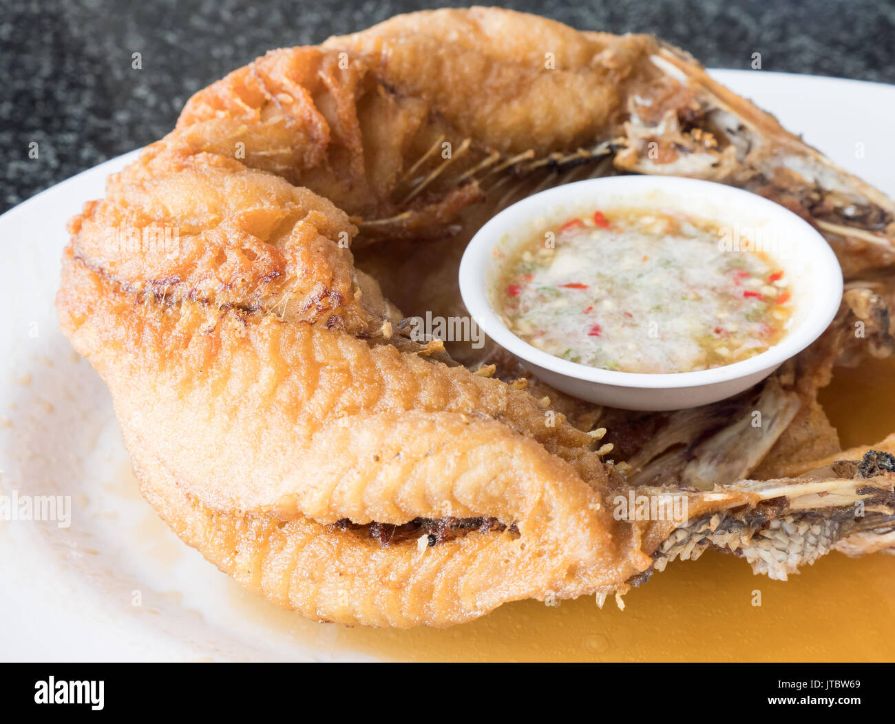 Fried snapper fish with the spicy sauce in the traditional Thai style ...