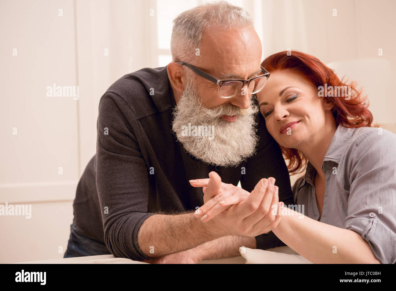 affectionate husband holding wife's hand while spending time Stock ...