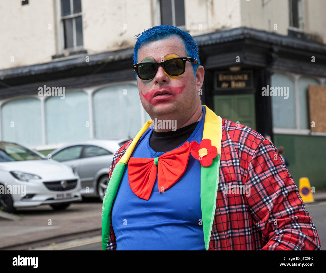 Large white man with face painted like a clown marching at the Stockton ...