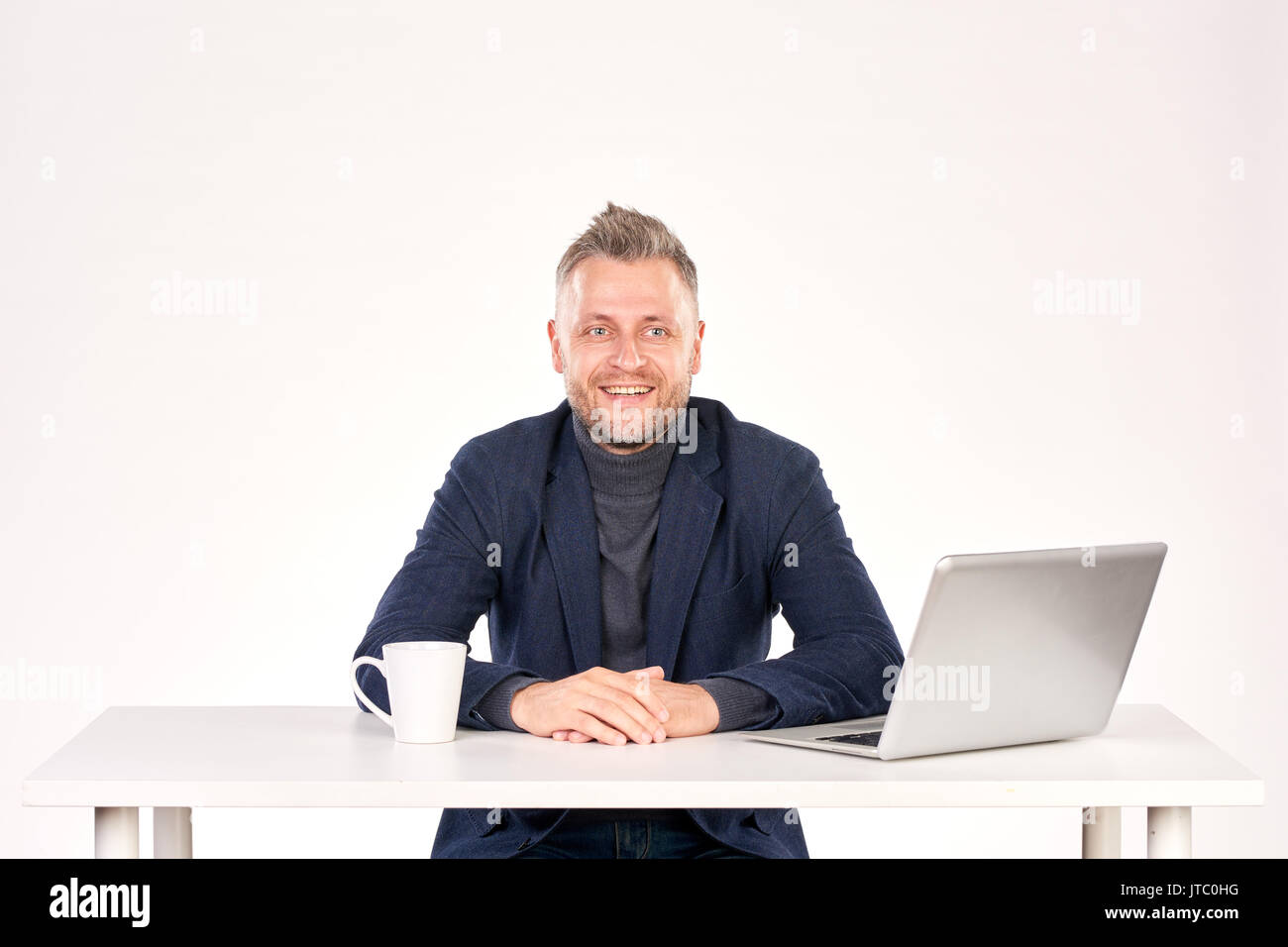 Man laughing sitting desk hi-res stock photography and images - Alamy