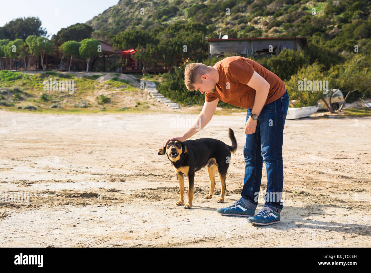 pet, domestic animal, season and people concept - happy man with his ...