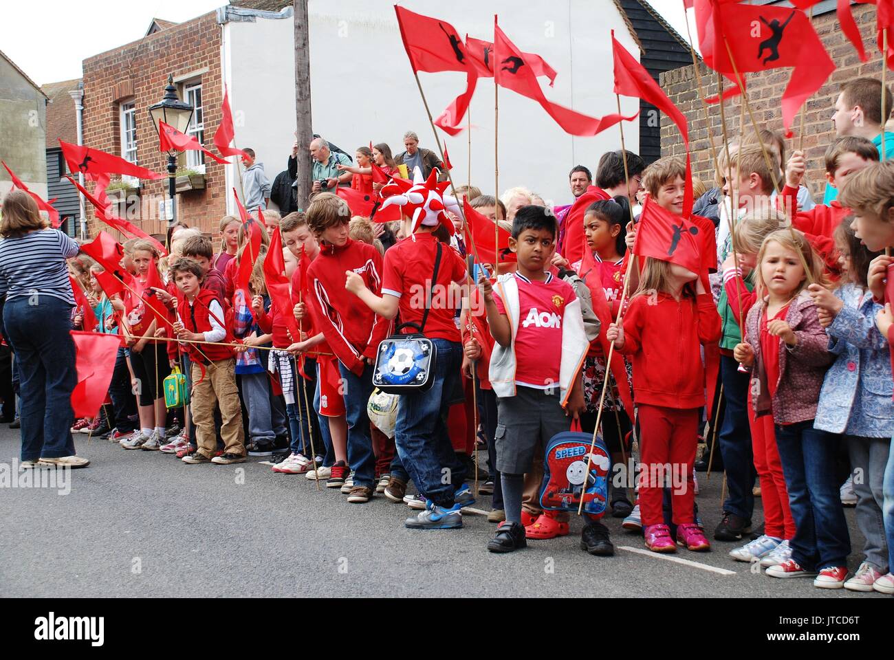 Children line the streets for an Olympic torch relay event at Rye in ...