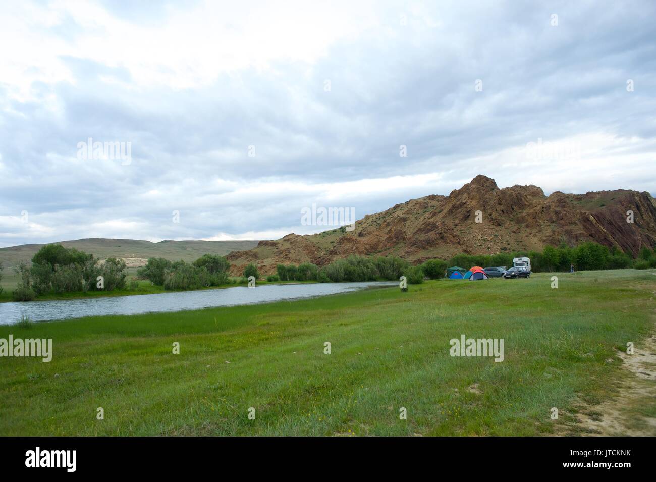 Beautiful sunny valley between mountains with lush clouds Stock Photo ...