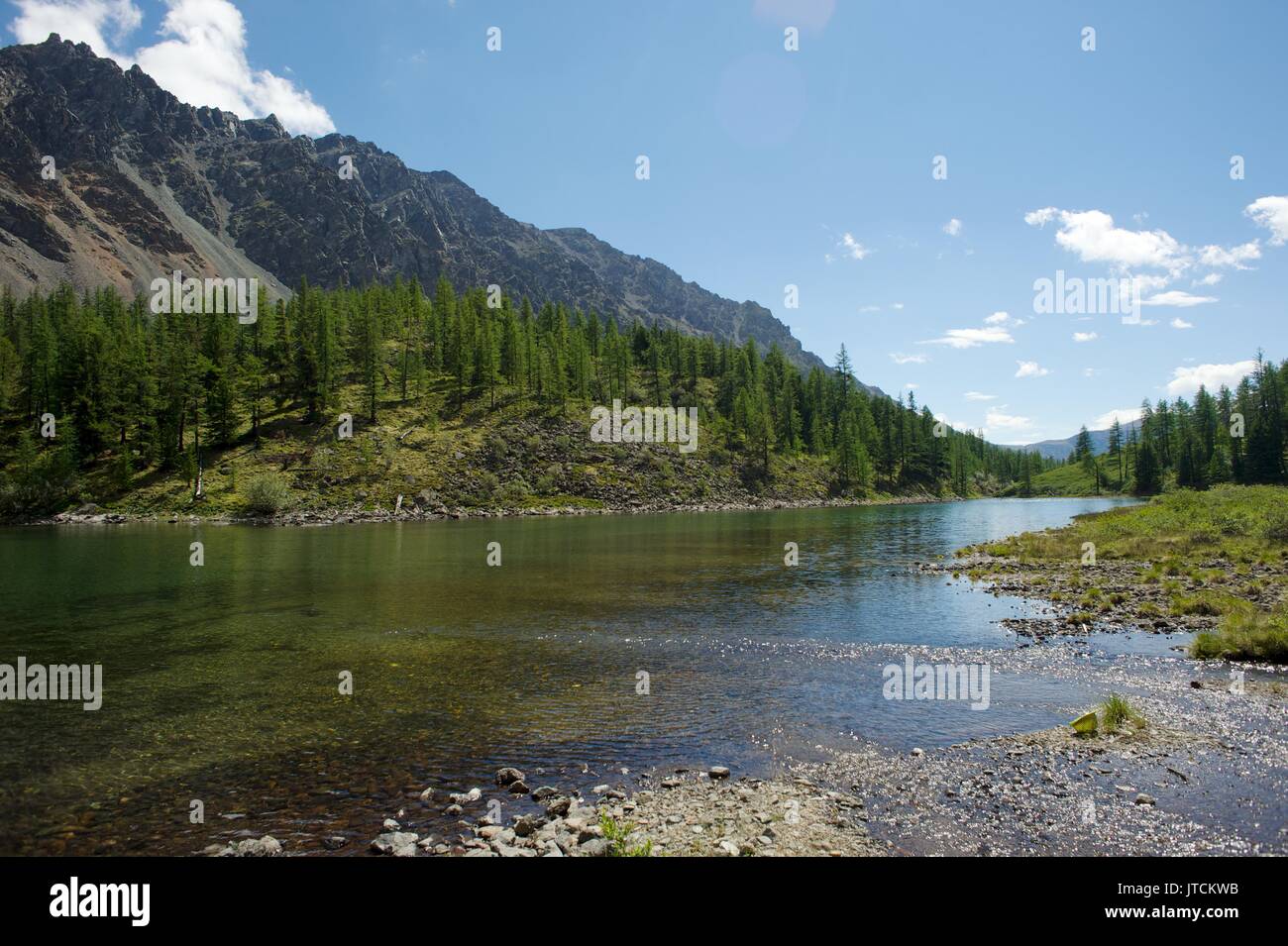 Beautiful sunny valley between mountains with lush clouds Stock Photo ...