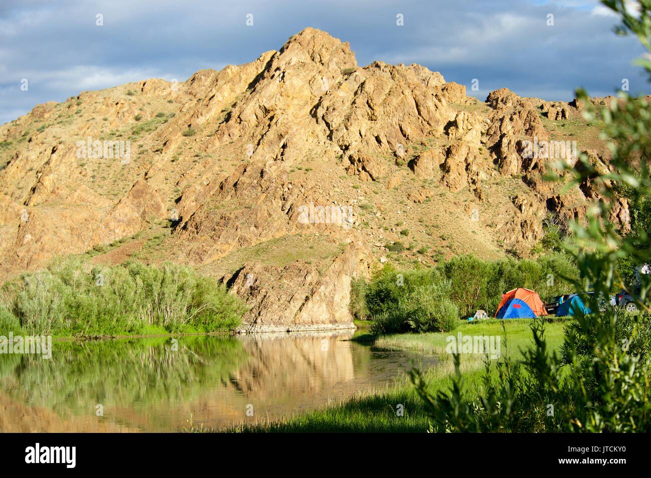 Beautiful sunny valley between mountains with lush clouds Stock Photo ...