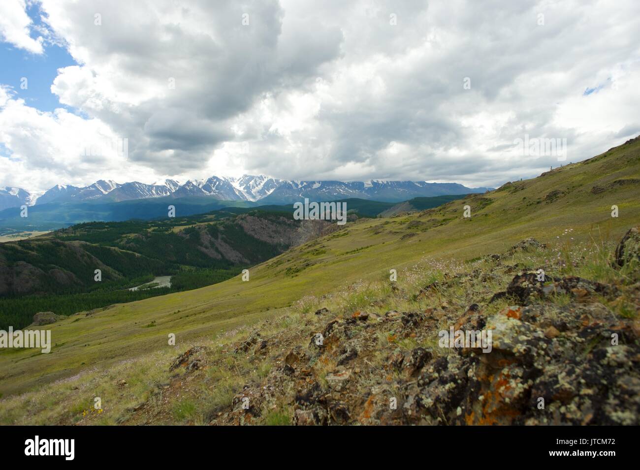 Beautiful sunny valley between mountains with lush clouds Stock Photo ...