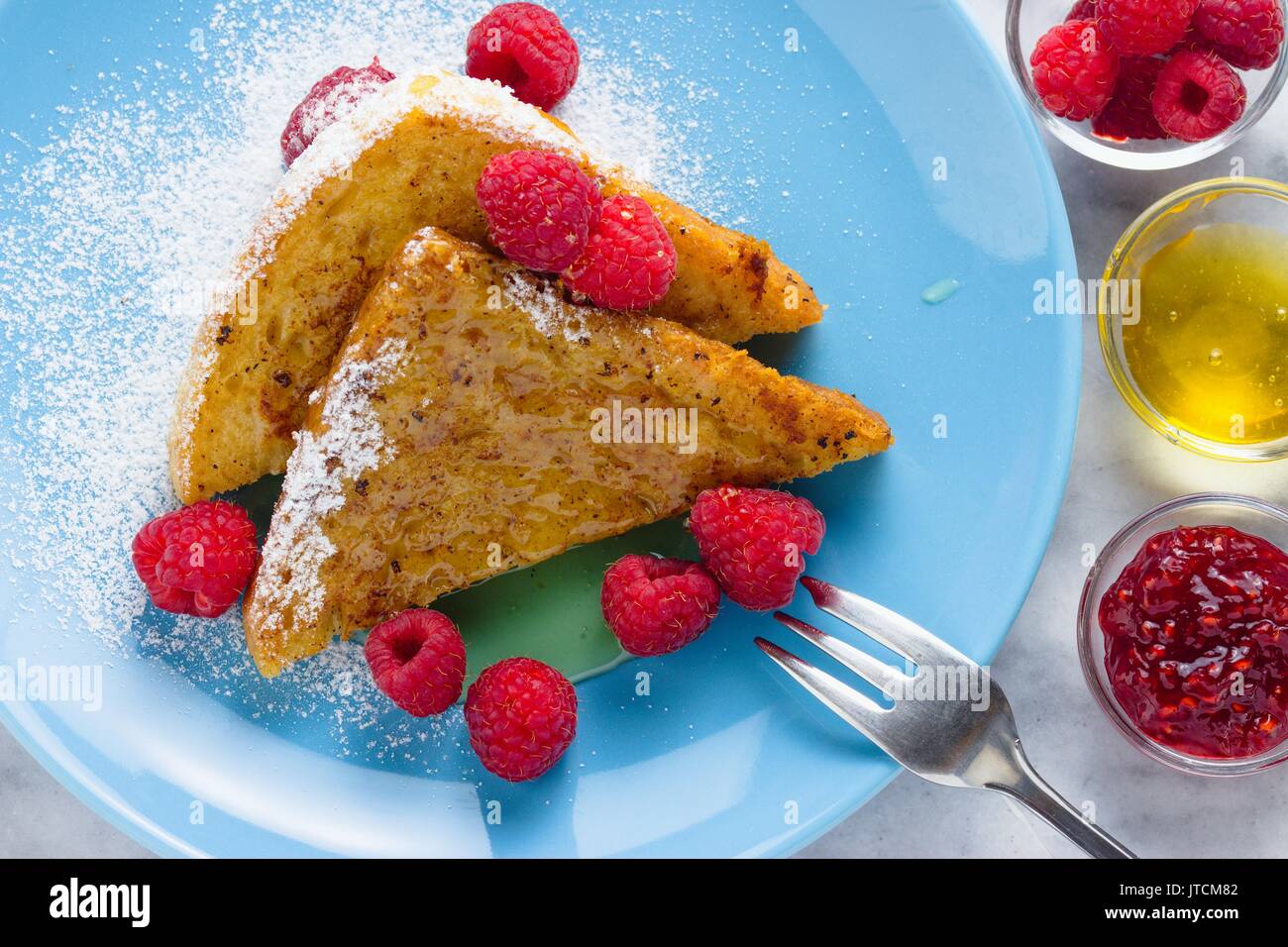 French toast with raspberries and honey Stock Photo - Alamy