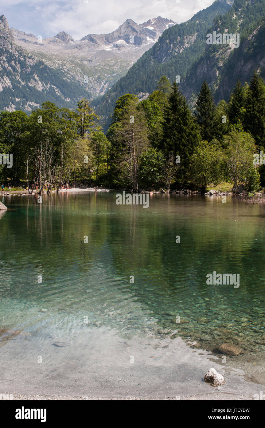 The alpine lake in the Mello Valley, Val di Mello, green valley ...