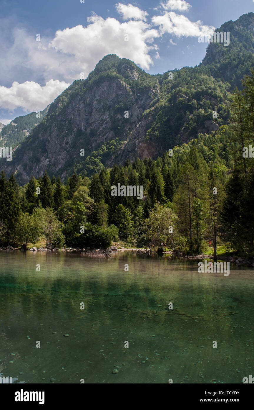The alpine lake in the Mello Valley, Val di Mello, green valley ...