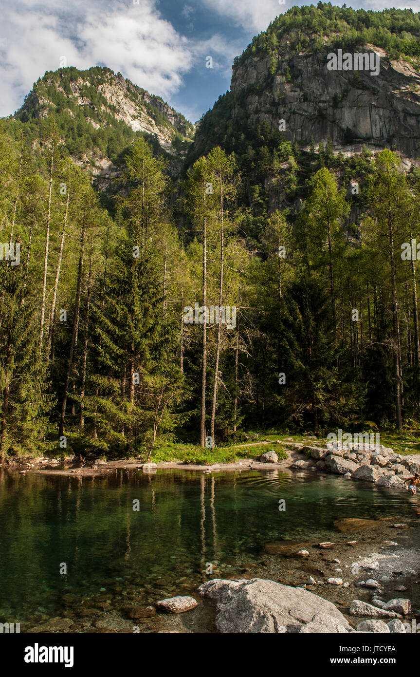 The alpine lake in the Mello Valley, Val di Mello, green valley ...