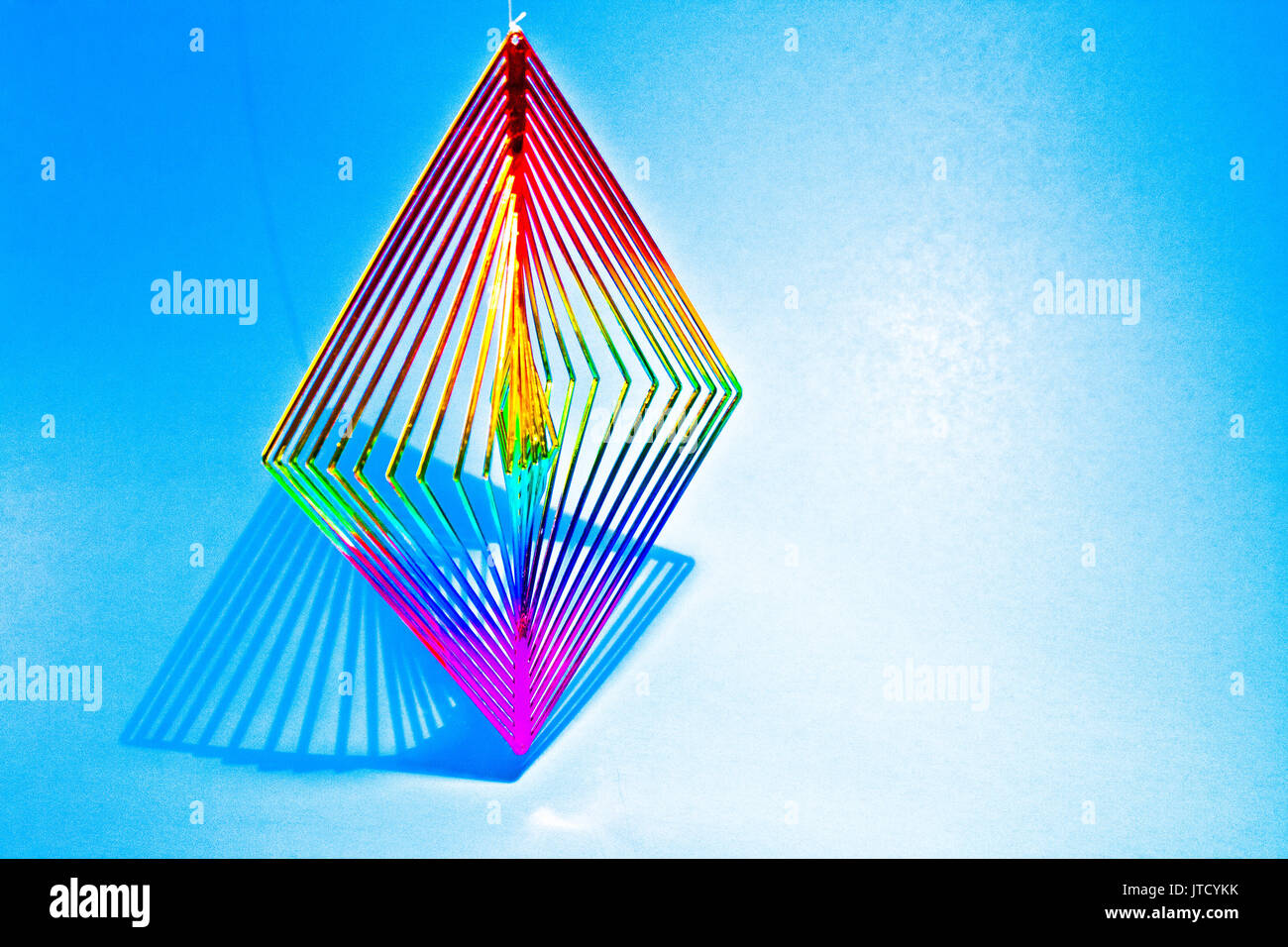 A multi-color diamond-shaped wind spinner forms abstract patterns of ...