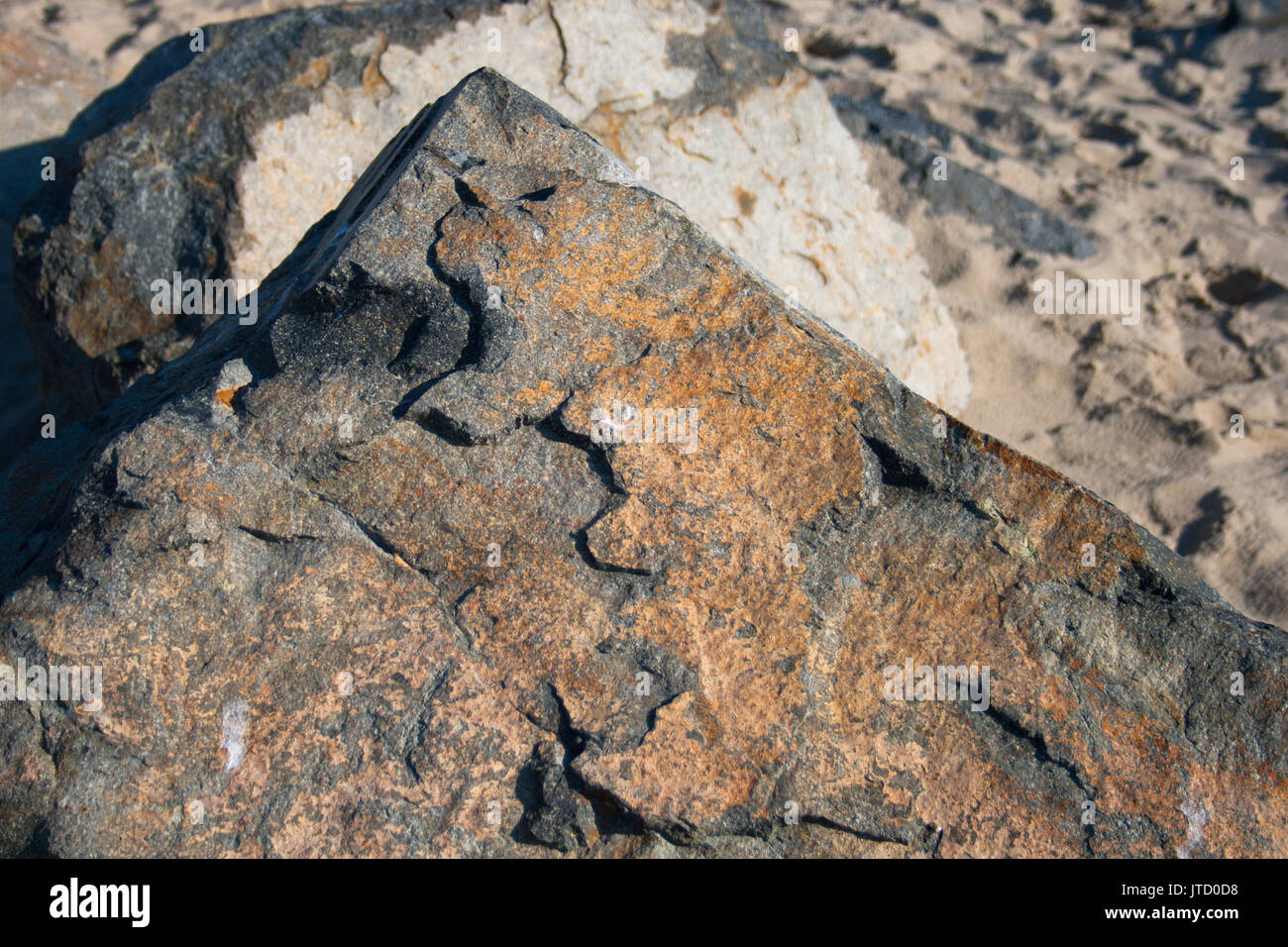 Gray and rust patterns on rock groups on the beach at Venice, CA Stock ...
