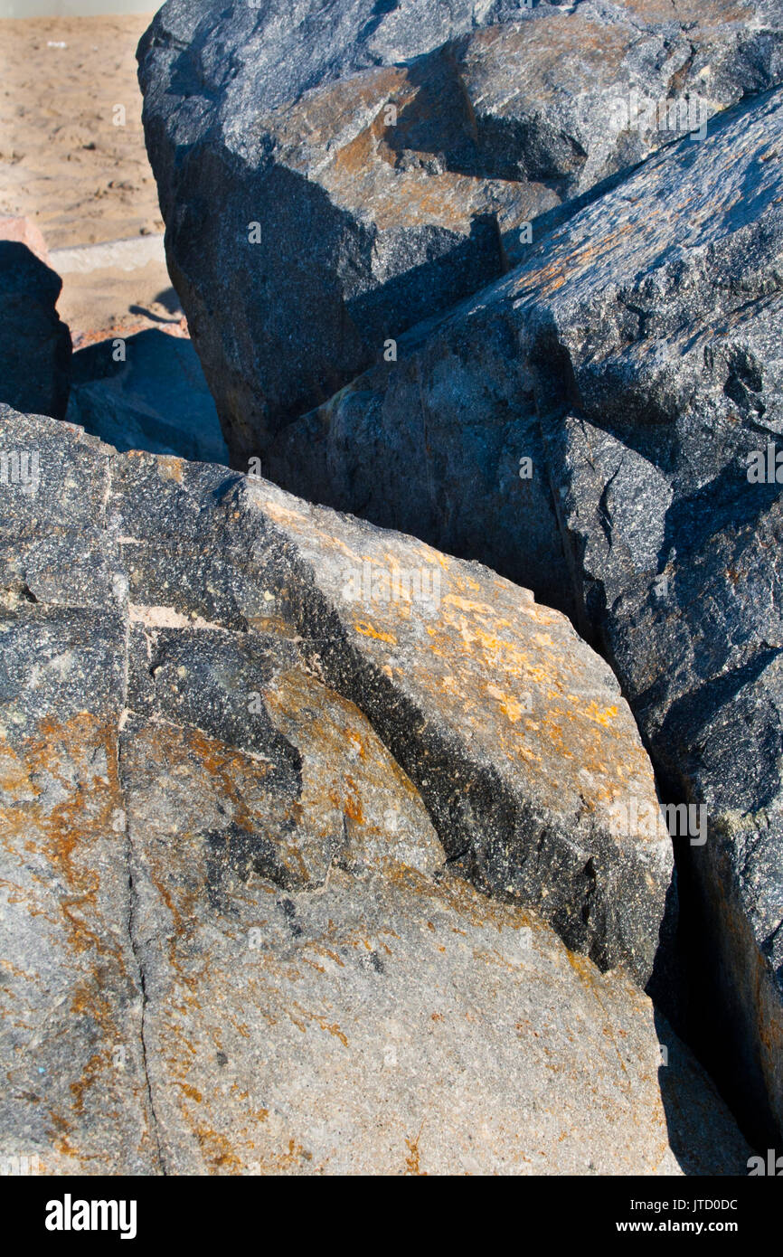 Gray and rust patterns on rock groups on the beach at Venice, CA Stock ...