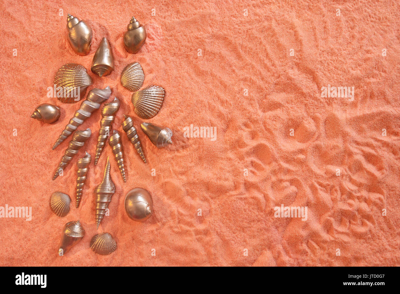 Gold and natural colored sea shells form patterns on coral sand Stock ...