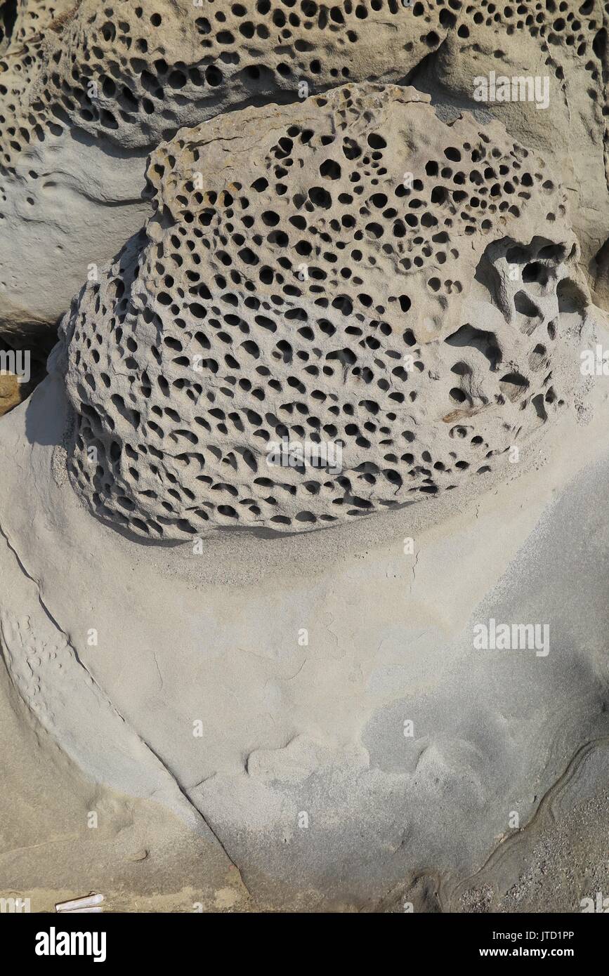 Perforated rock texture and background Stock Photo - Alamy