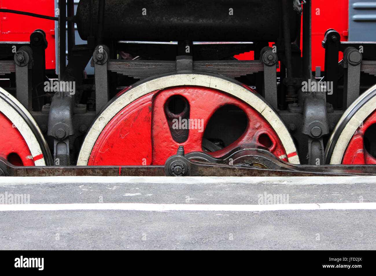 Powerful wheels of old locomotive stands on the railroad tracks on the ...