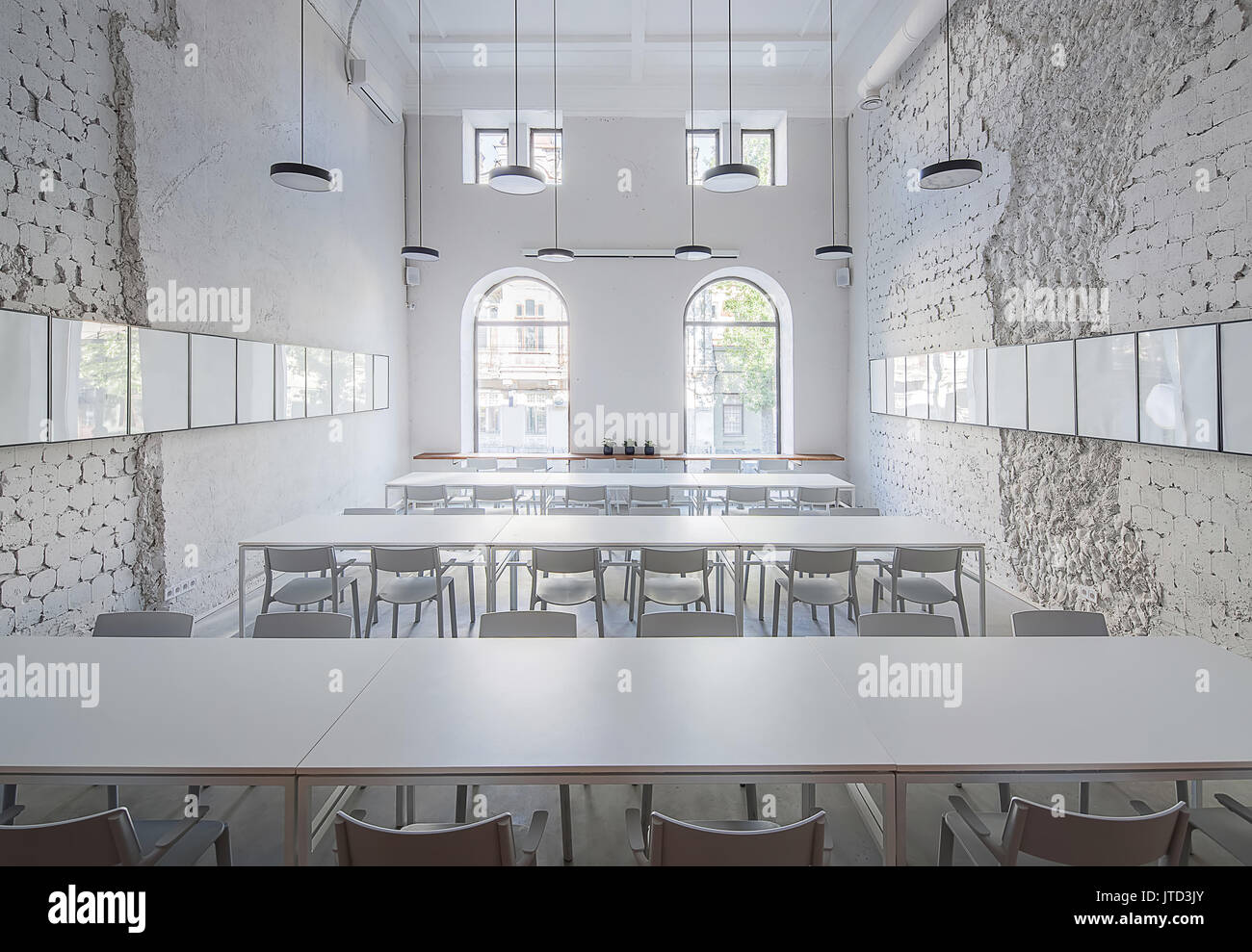 Nice hall in a cafe with shabby light walls and gray floor. There are ...