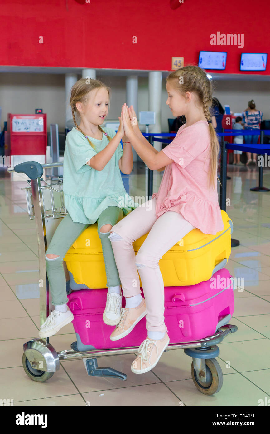 Adorable little girls having fun in airport waiting for boarding Stock ...